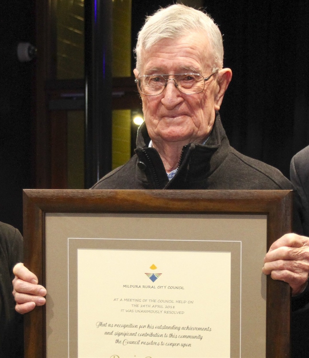 Flags at half-mast, public sites lit up to honour Denis Ryan AM